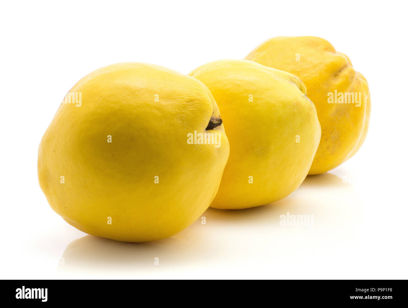 Three yellow quinces isolated on white background raw ripe whole Stock ...