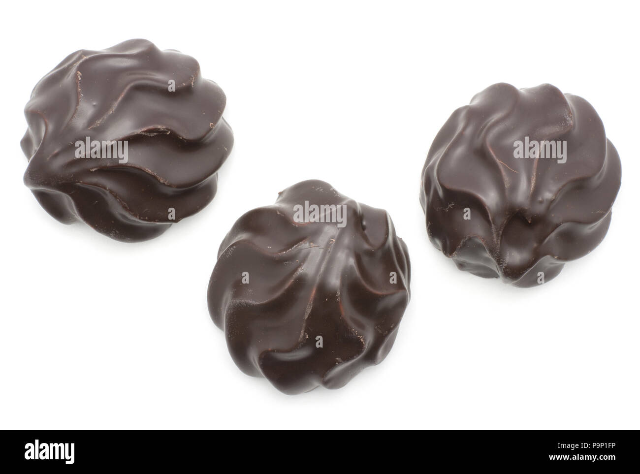 Three dark chocolate-coated zefir top view isolated on white background ...
