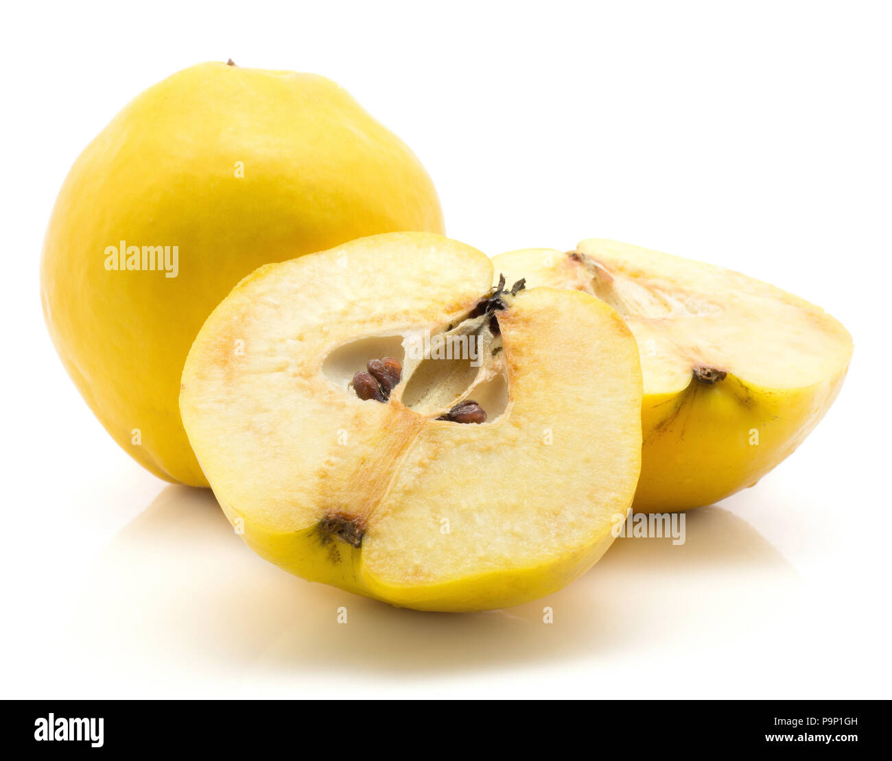 One yellow quince with two halves isolated on white background raw ripe ...