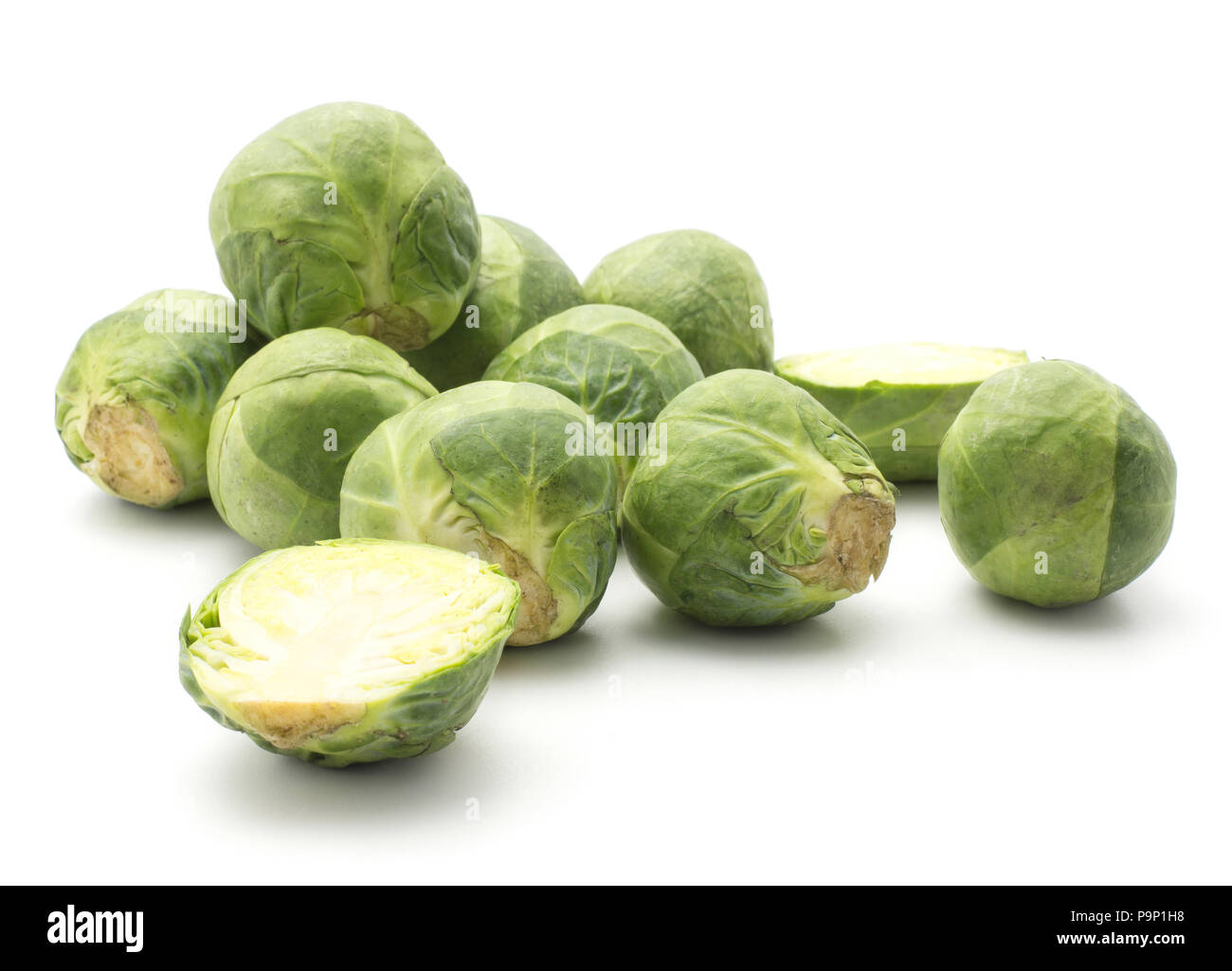 Raw Brussels sprout stack isolated on white background heads two sliced ...