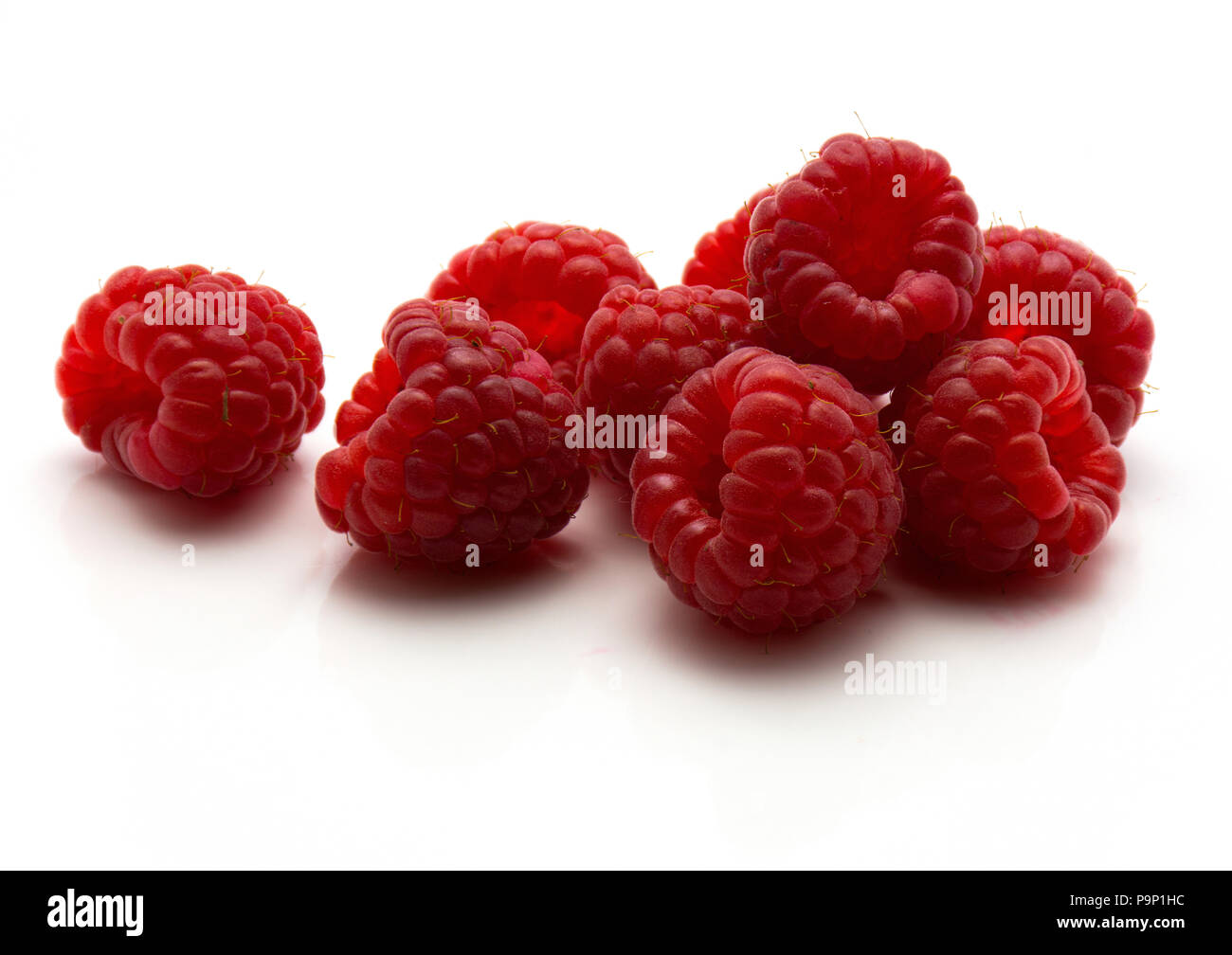 Red raspberries isolated on white background heap Stock Photo - Alamy