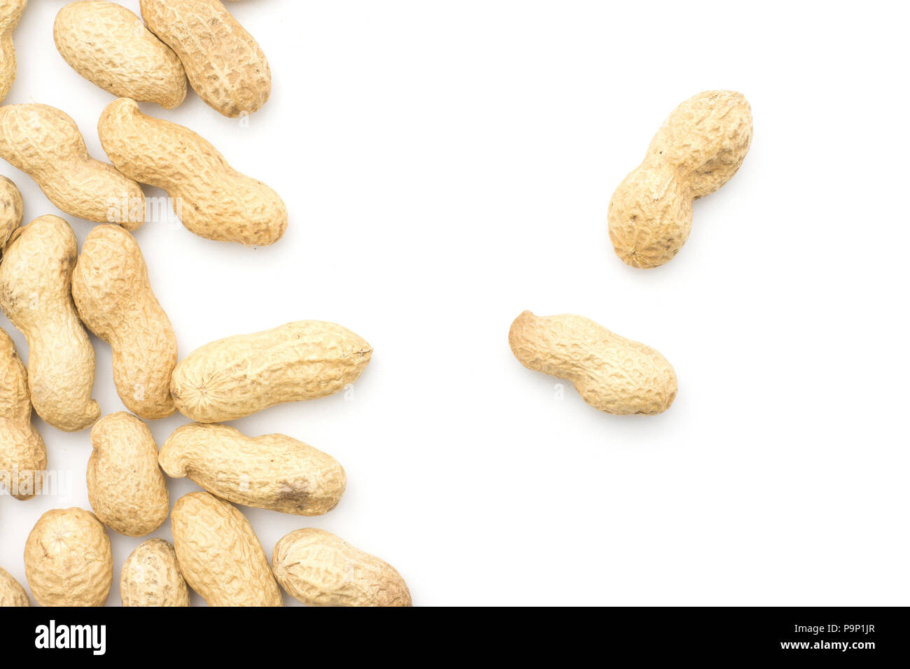 Unshelled peanuts top view isolated on white background left side two ...