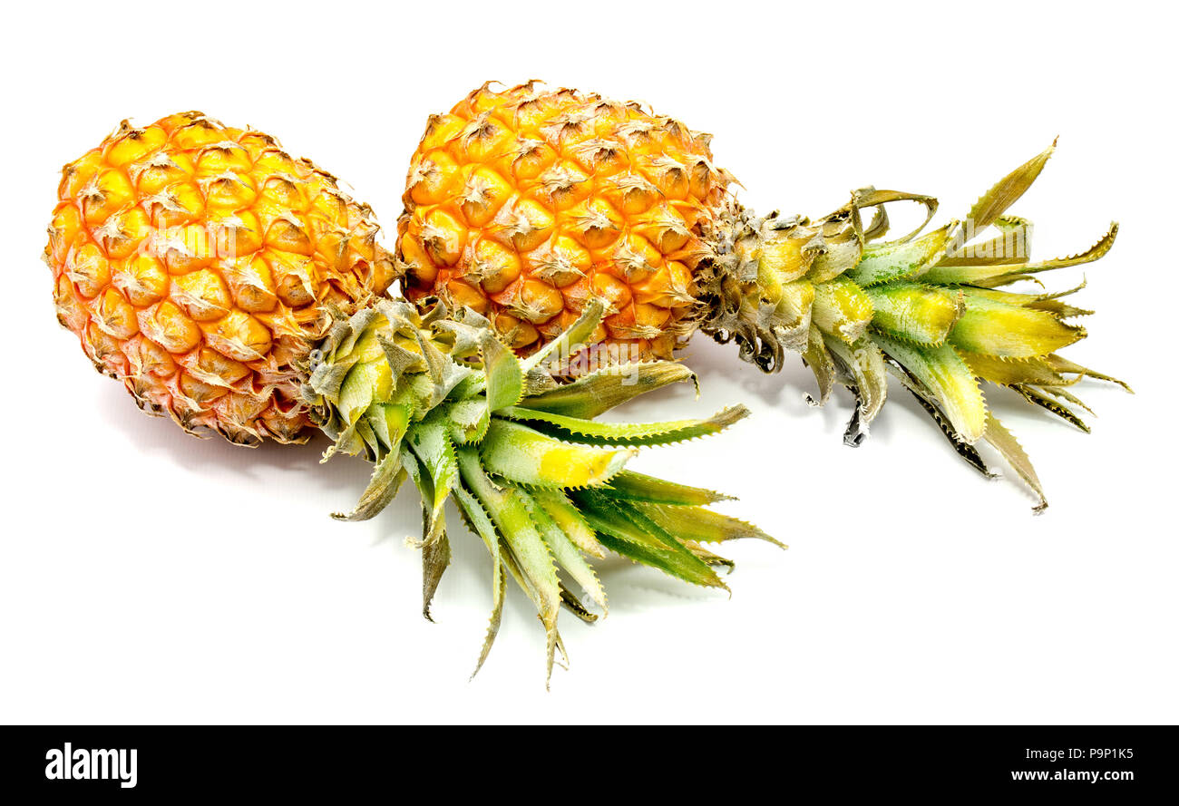 Two whole pineapples isolated on white background Stock Photo - Alamy