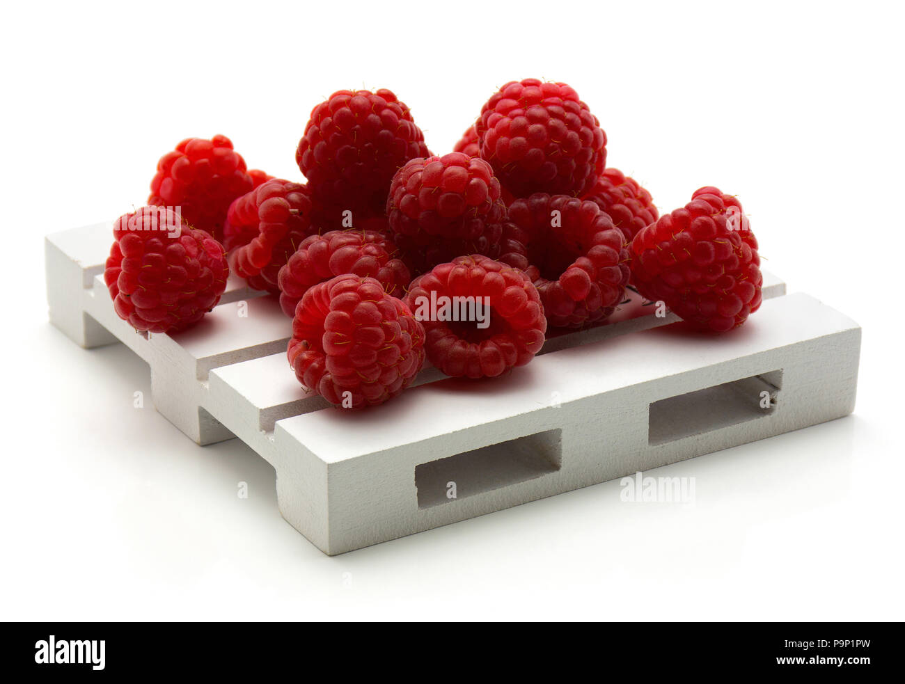Red raspberries on pallet isolated on white background Stock Photo - Alamy