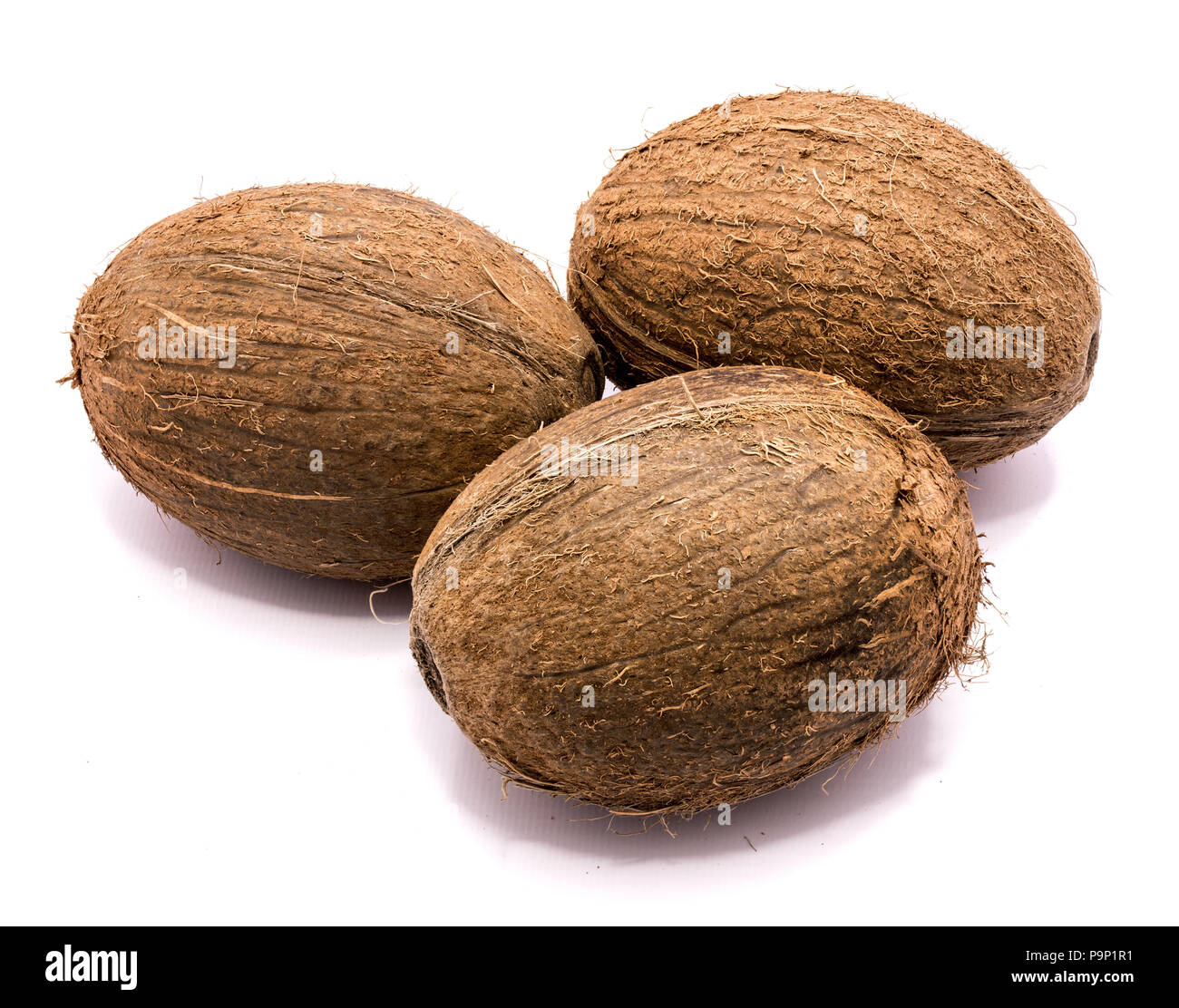 Three whole coconuts isolated on white background Stock Photo - Alamy