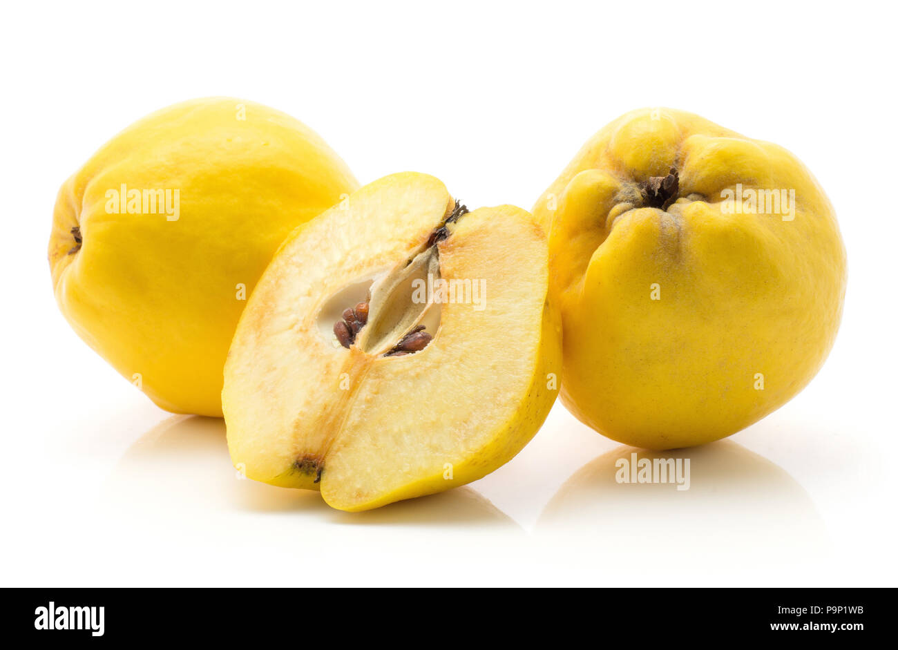 Two yellow quinces with one half isolated on white background raw ripe ...