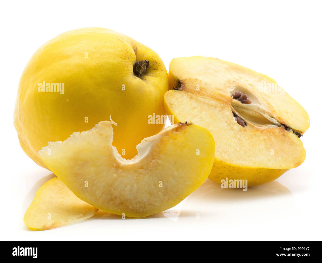 Yellow quince with one cross section half and two slices without seeds ...