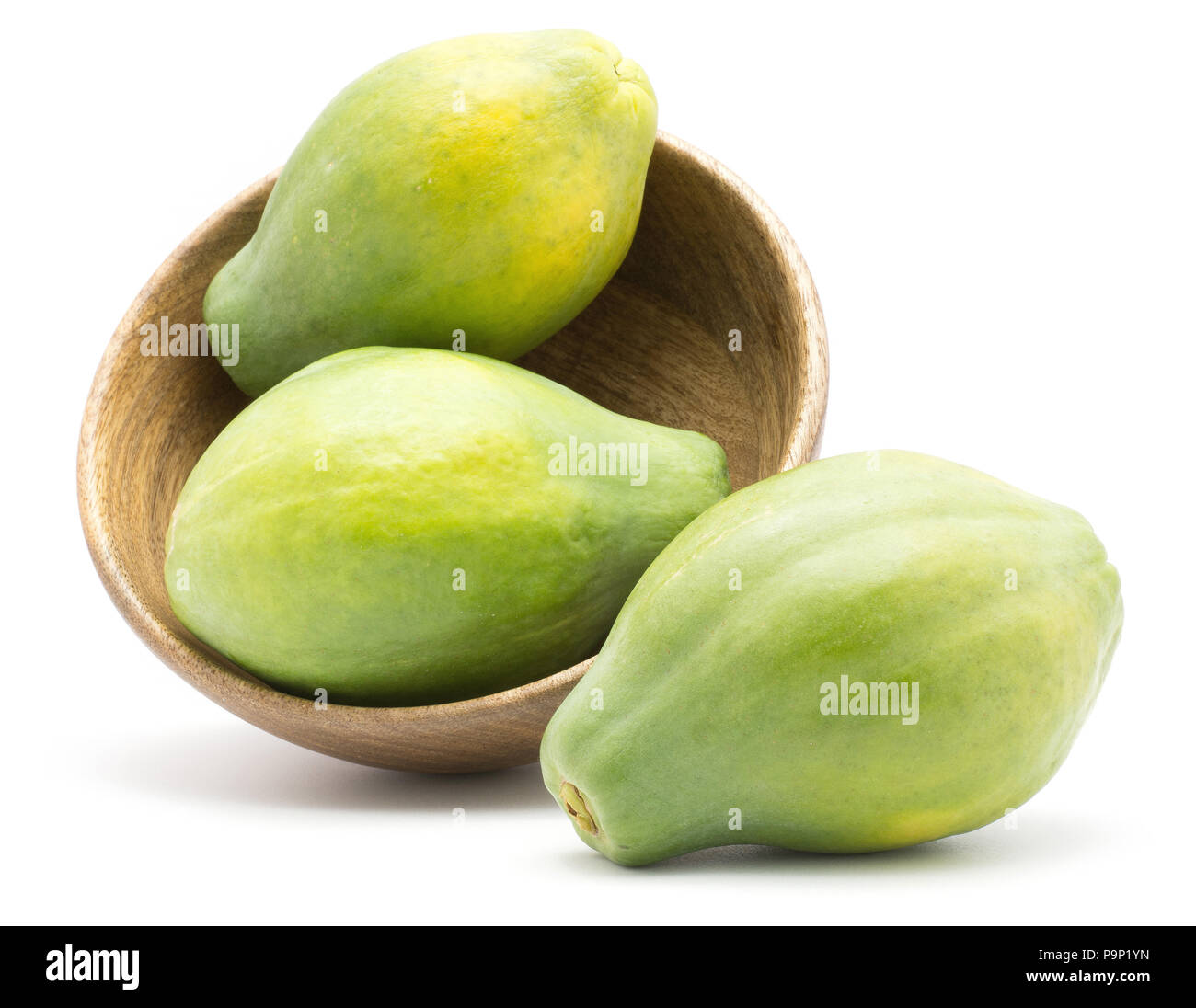 Green papaya (pawpaw, papaw) in a wooden bowl isolated on white ...