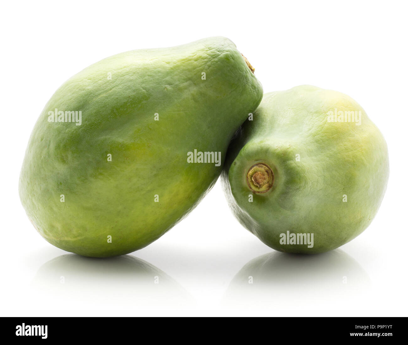 Two green papaya (pawpaw, papaw) isolated on white background fresh ...