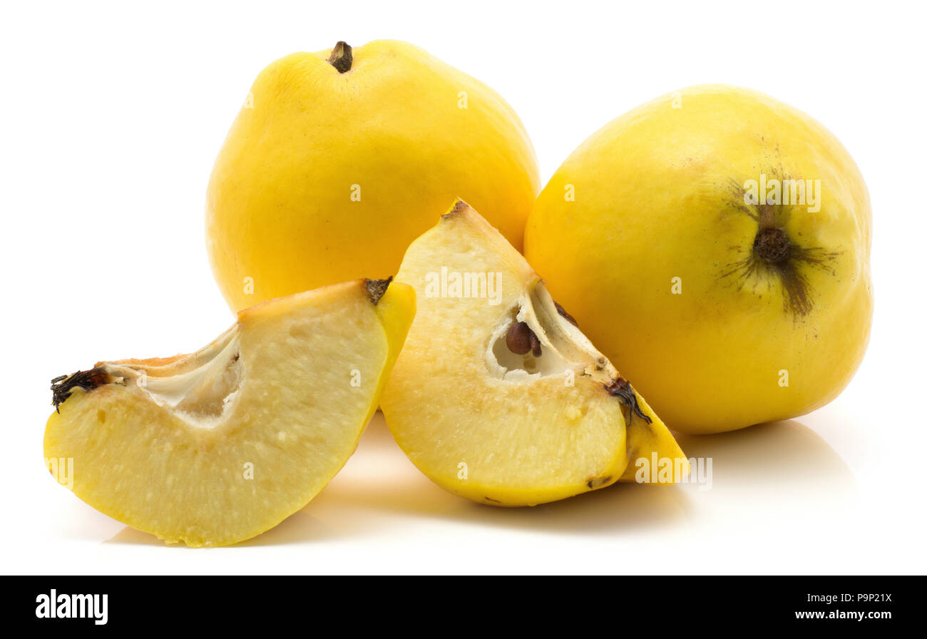 Two yellow quinces set with slices isolated on white background raw ...