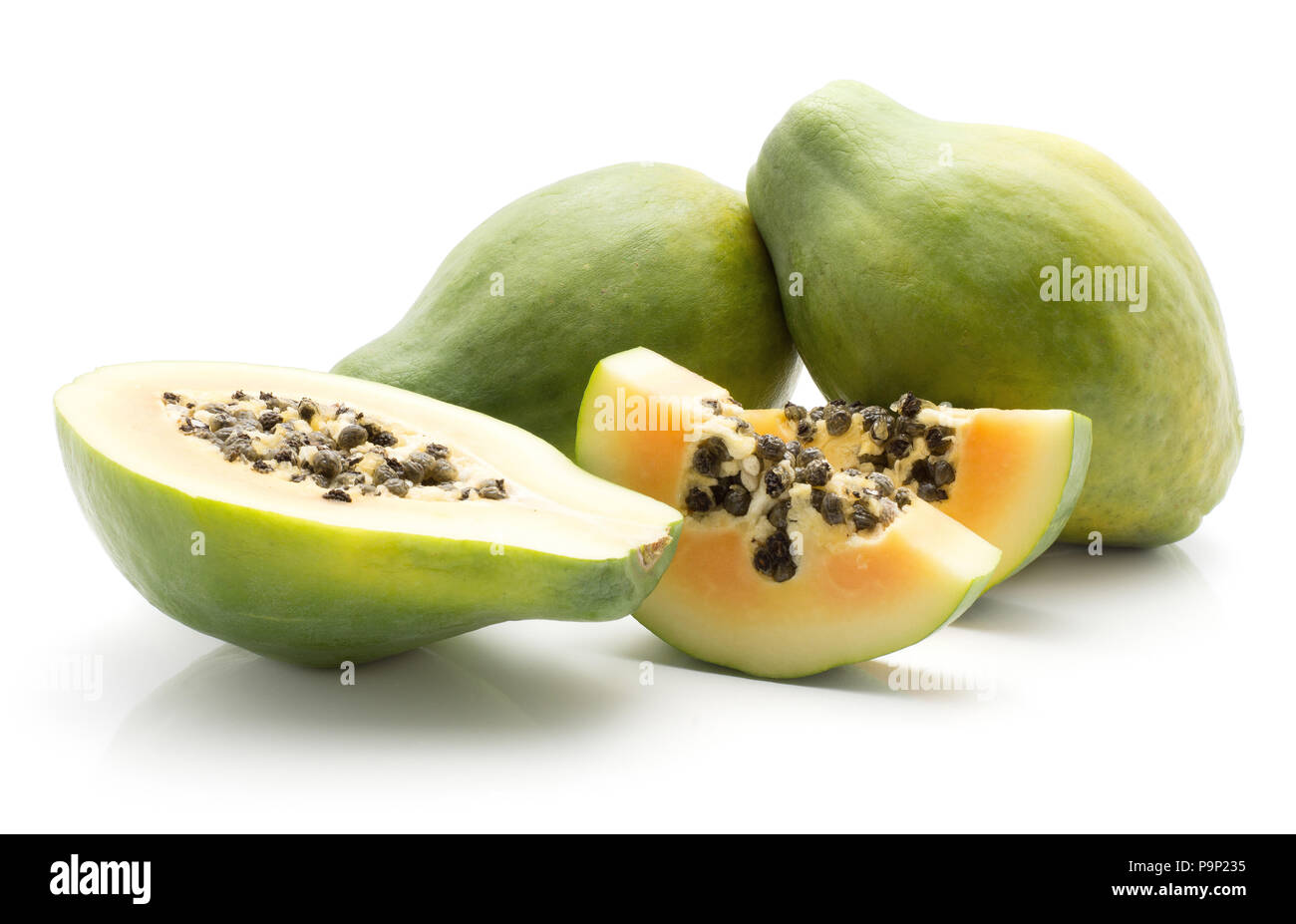 Green papaya (pawpaw, papaw) two whole one half and two slices with ...