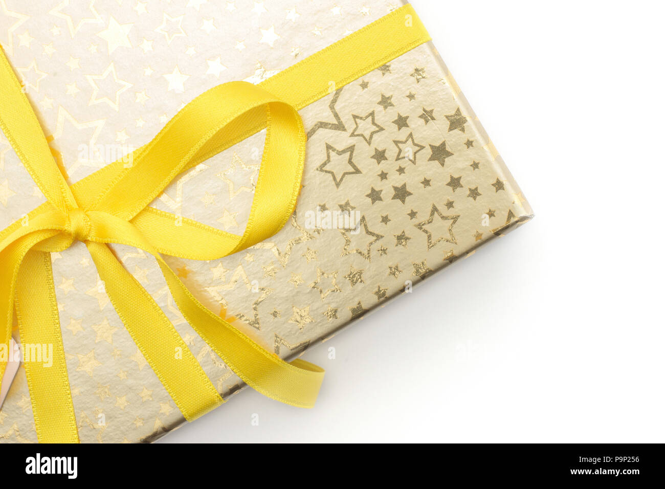 Present box tied by yellow ribbon and decorated by a lot of shiny stars ...