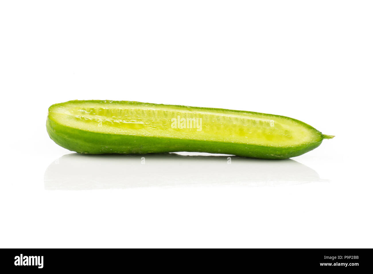 One fresh mini cucumber section half isolated on white background Stock ...