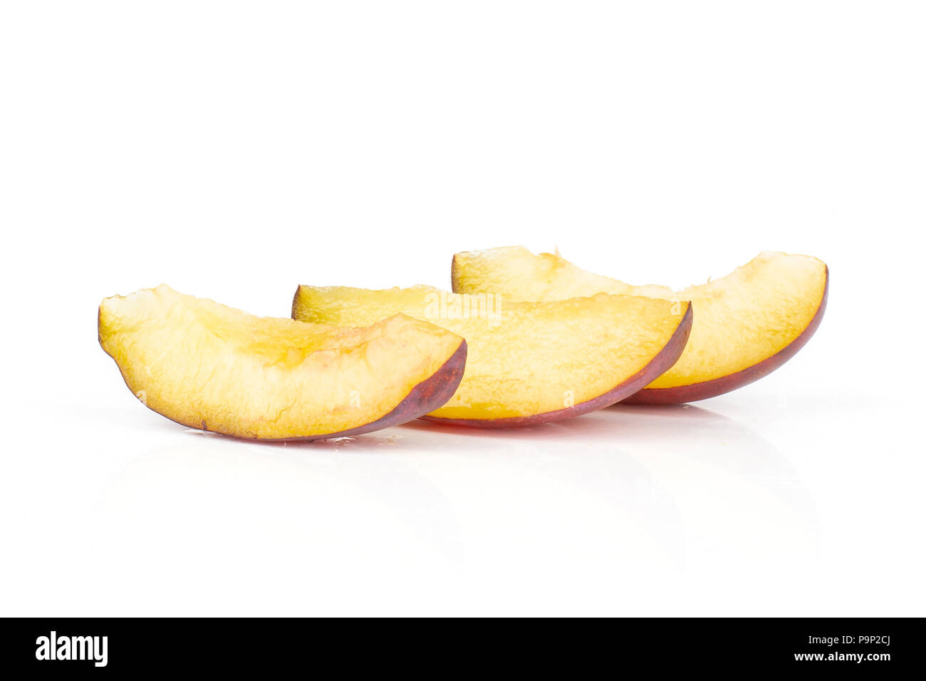 Group of three slices of fresh violet-blue plum vibrant moyer variety ...