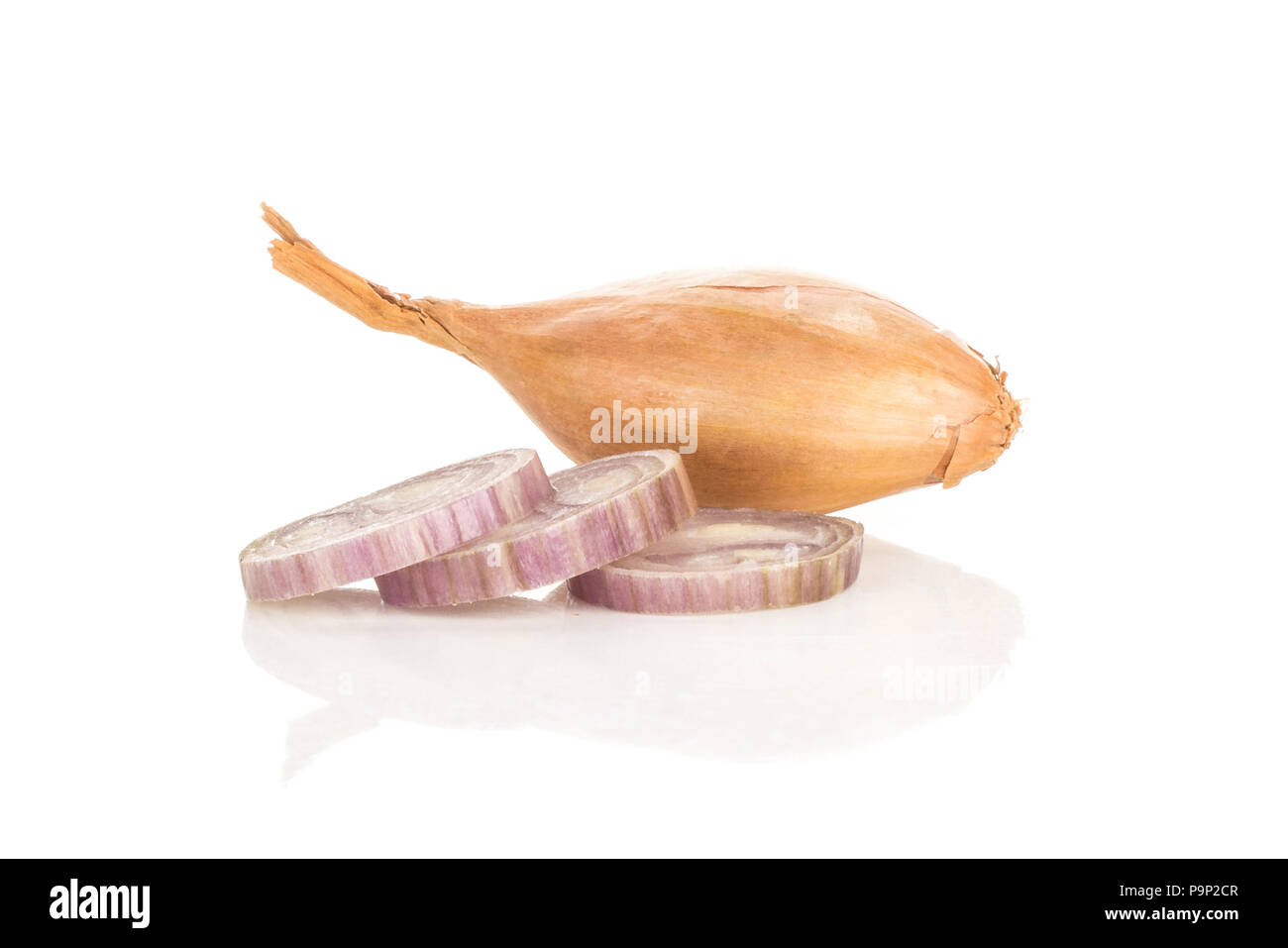 One golden shallot and three ring slices isolated on white background ...