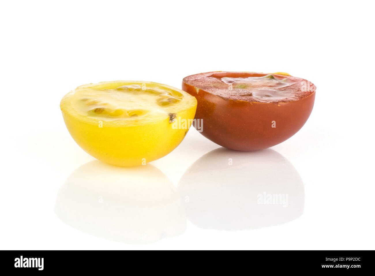 Two grape cherry tomatoes halves isolated on white background one ...