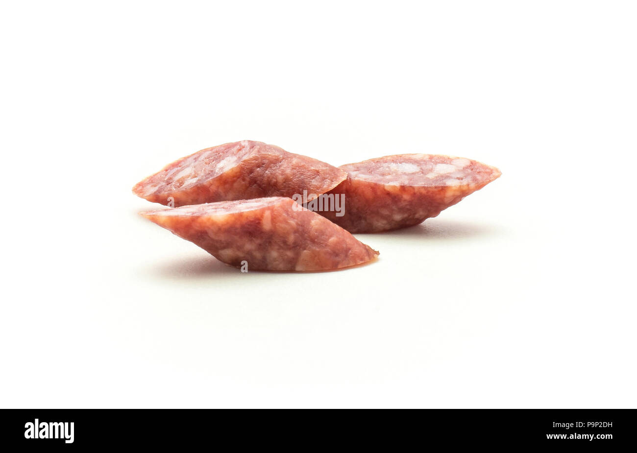 Three Hungarian dry sausages pepperoni cut pieces isolated on white ...