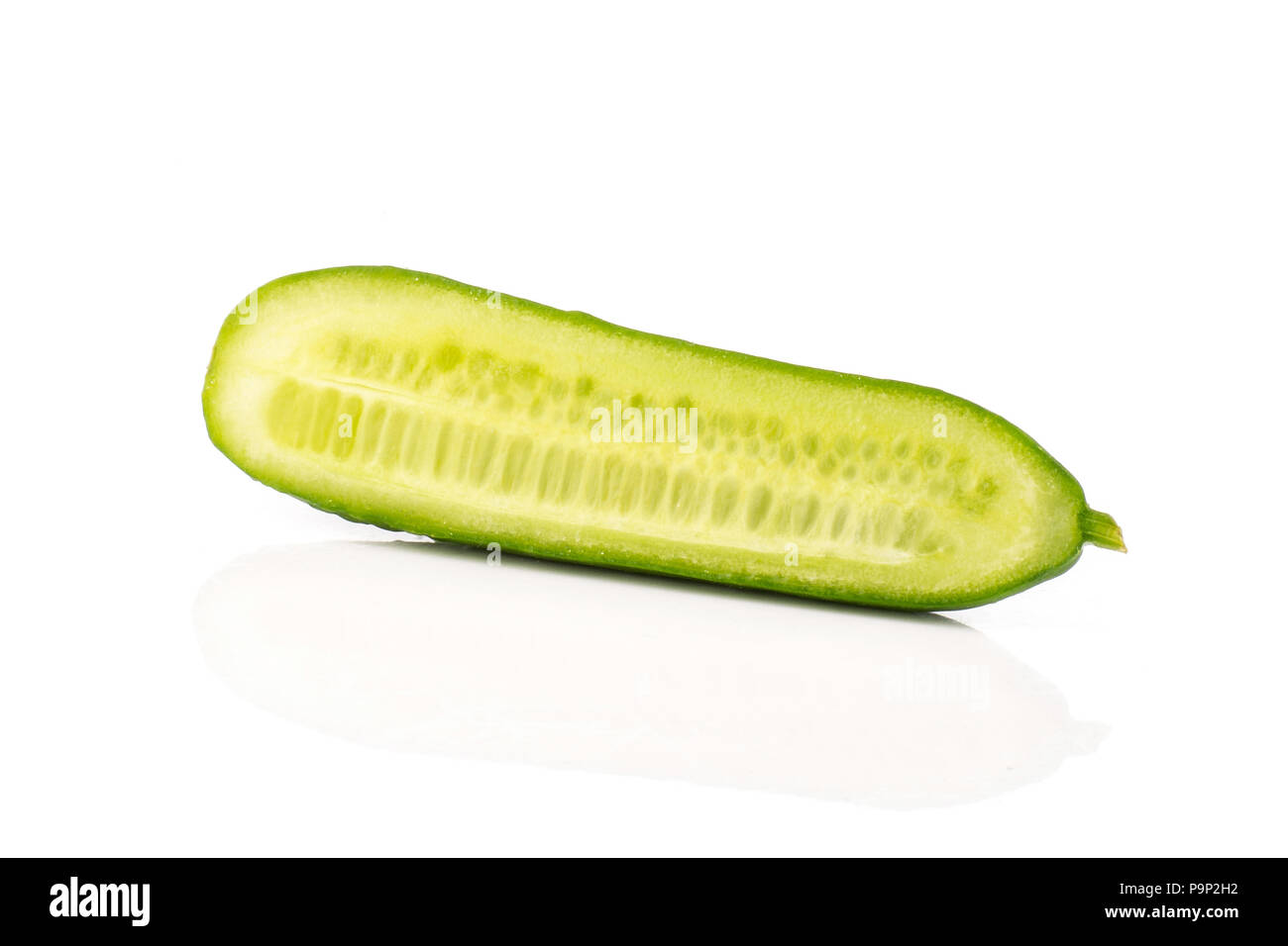 One fresh green mini cucumber section half isolated on white background ...