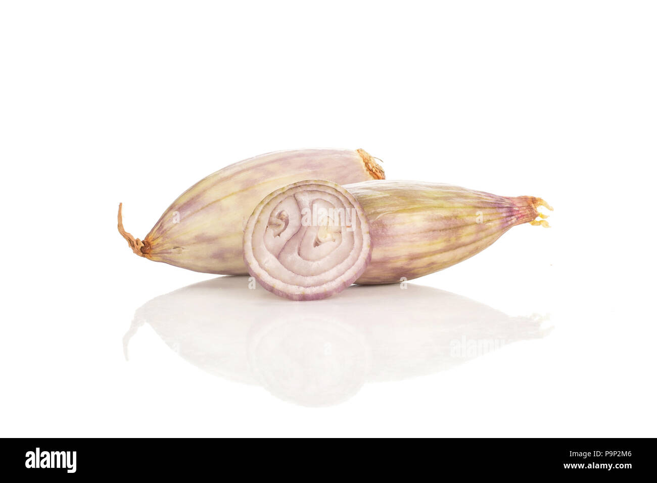 Two peeled shallots and one ring slice isolated on white background ...