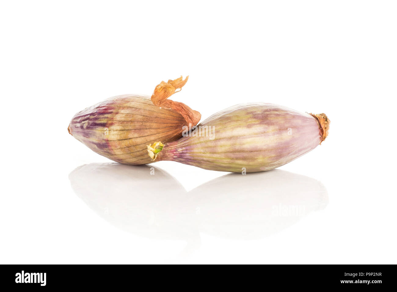 Two peeled green purple shallots isolated on white background Stock ...