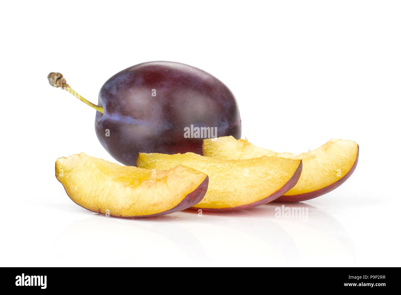 Group of one whole three slices of fresh violet-blue plum vibrant moyer ...