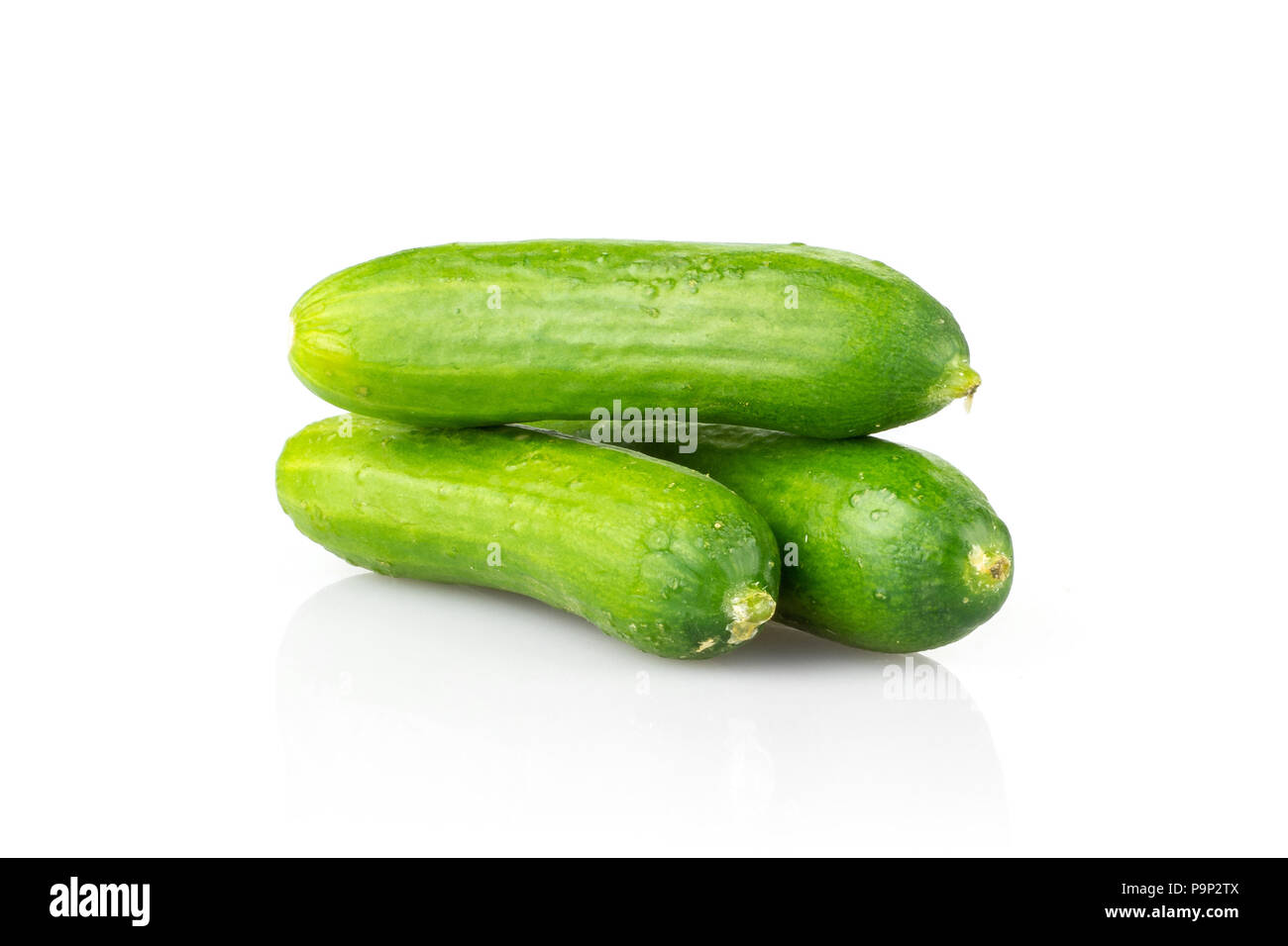 Three fresh mini cucumbers isolated on white background Stock Photo - Alamy
