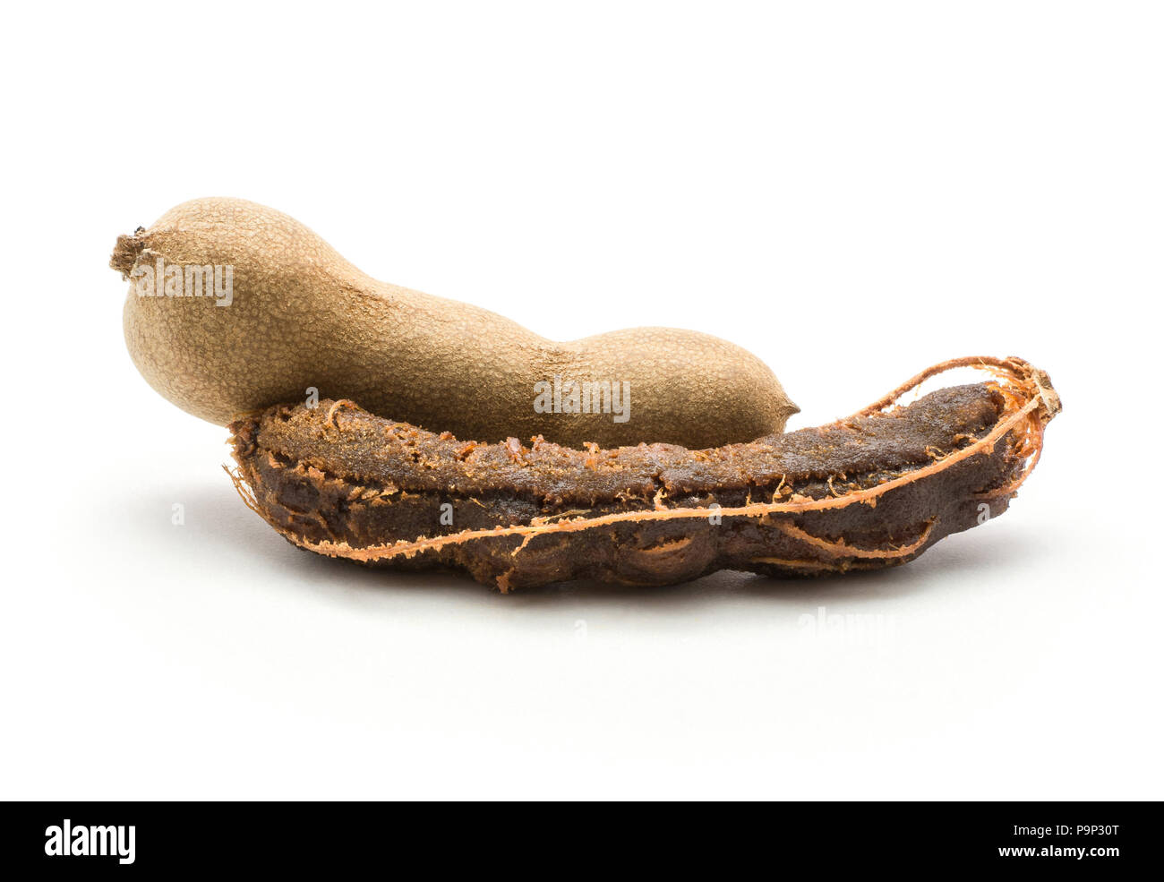 Two Indian dates tamarind one without shell isolated on white ...