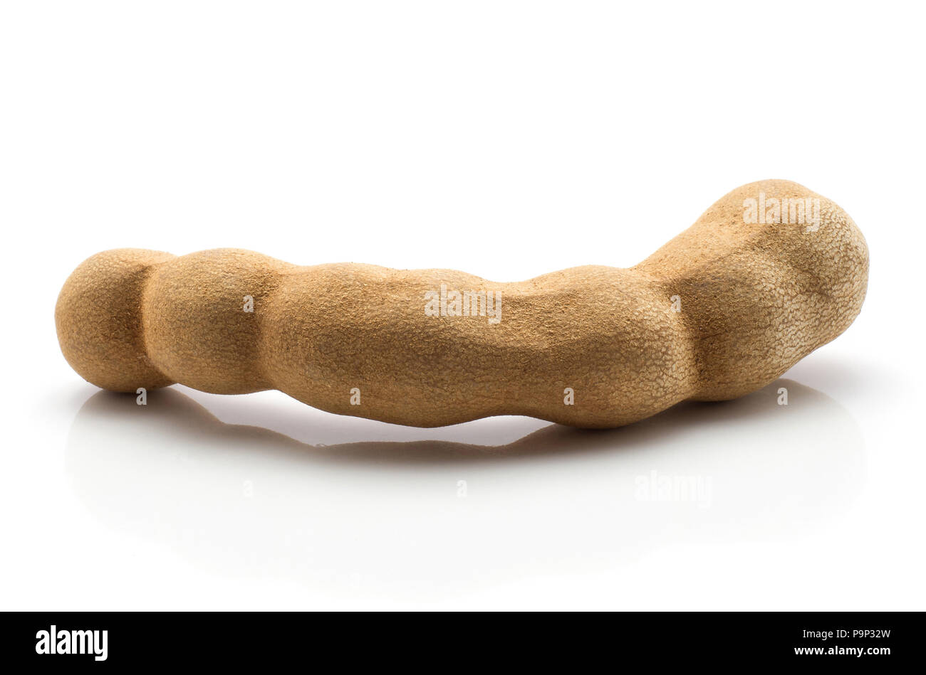 Tamarind isolated on white background one Indian date in a brown ...