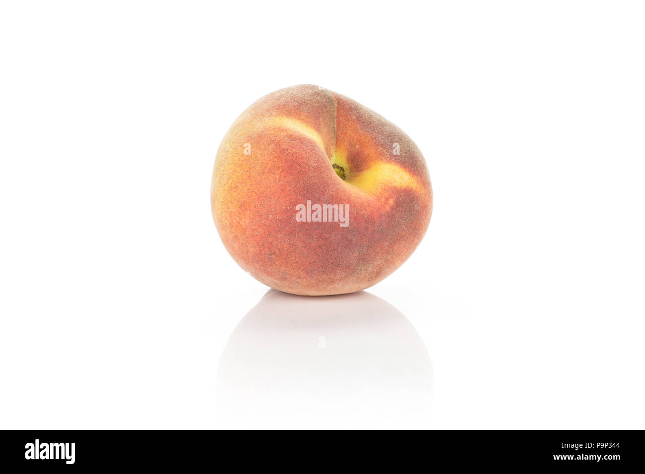 One ripe yellow peach with a red blush isolated on white background ...