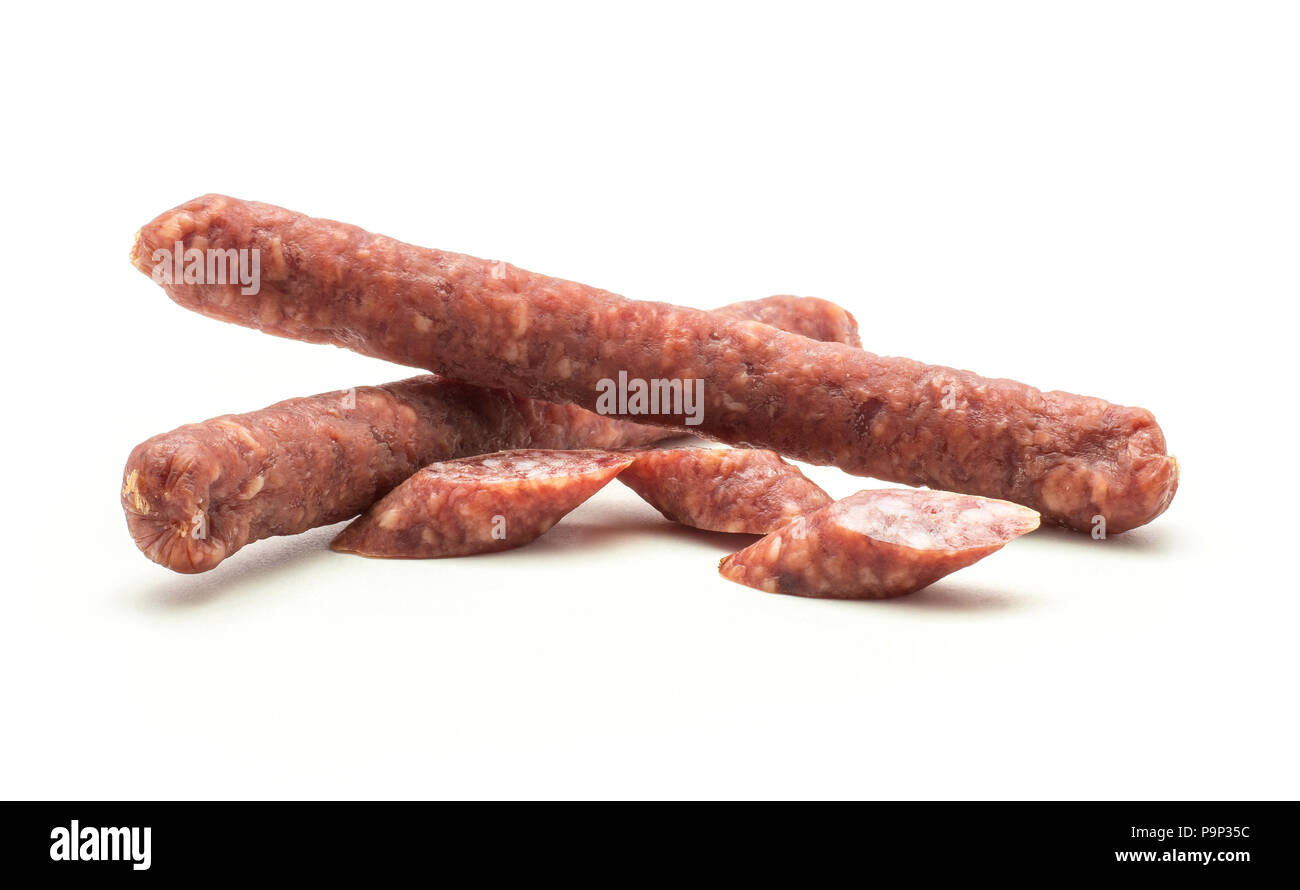 Two Hungarian dry sausages pepperoni with three cut pieces isolated on ...