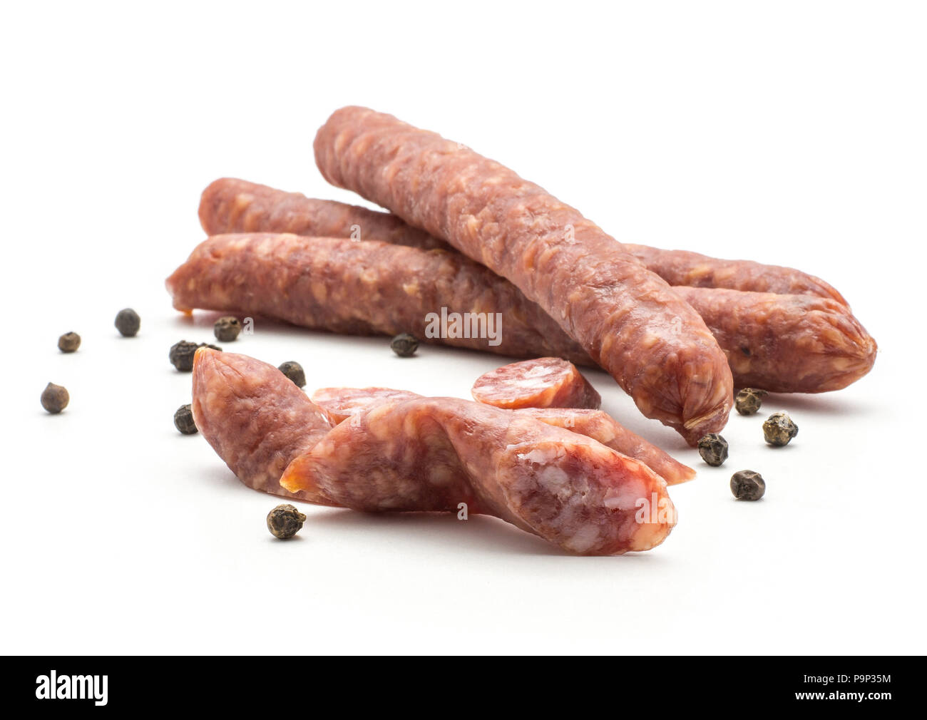 Three Hungarian dry sausages pepperoni with black pepper and cut pieces ...