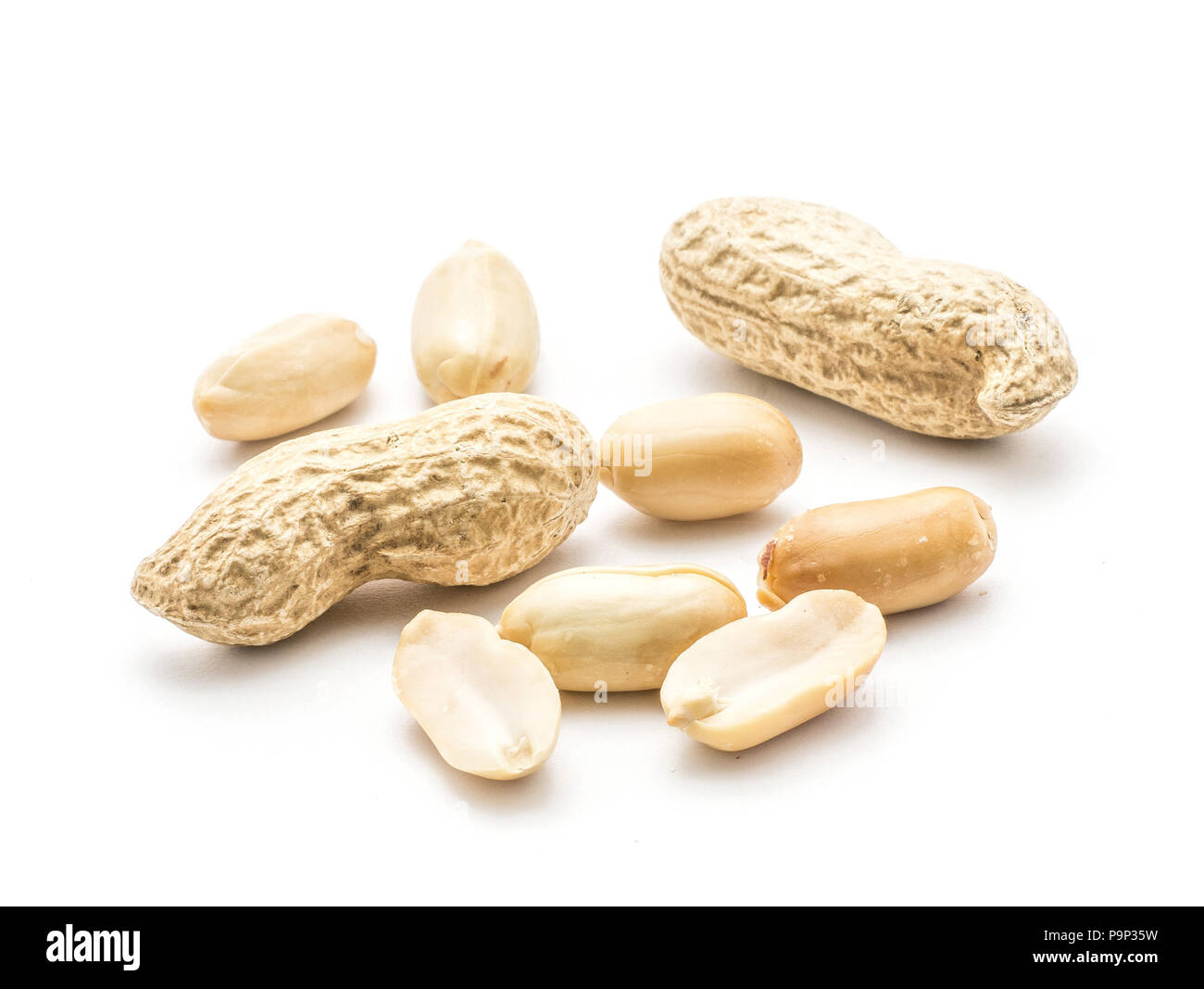 Two unshelled peanuts with raw nuts without husk and halves isolated on ...