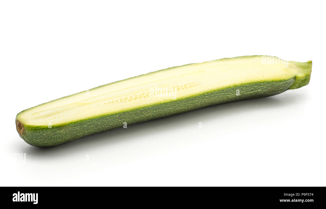 One green zucchini half isolated on white background long raw courgette ...