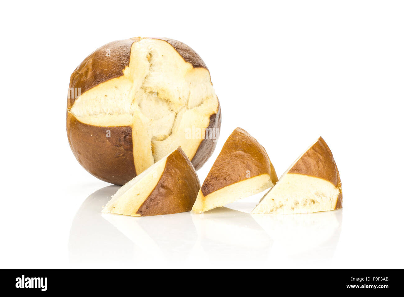 One Bavarian bread bun and three slices isolated on white background ...