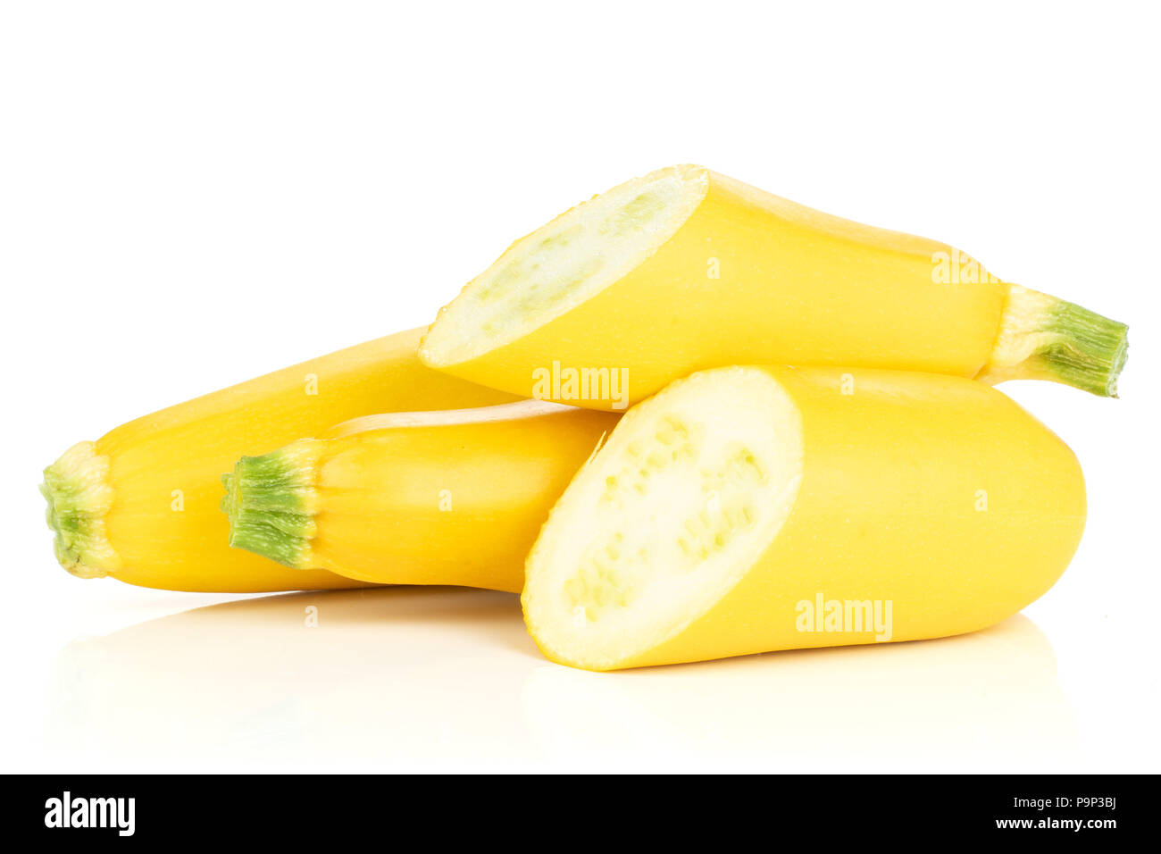 Group of two whole two halves of raw yellow zucchini isolated on white ...