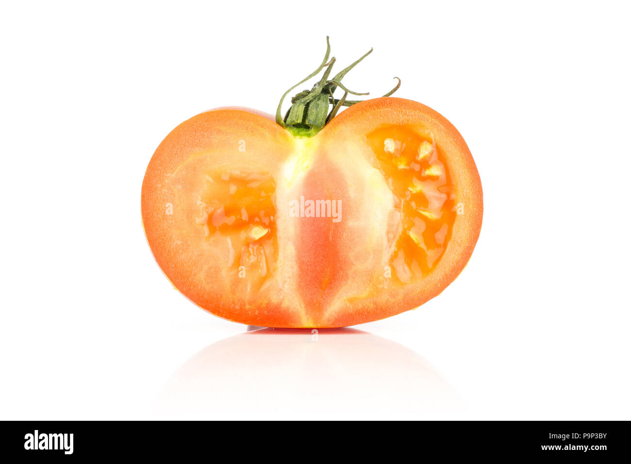 One red tomato section half with seeds isolated on white background ...