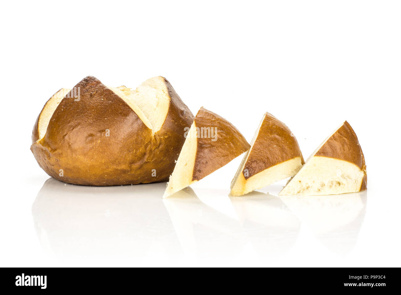 One Bavarian bread bun and three slices in row isolated on white ...