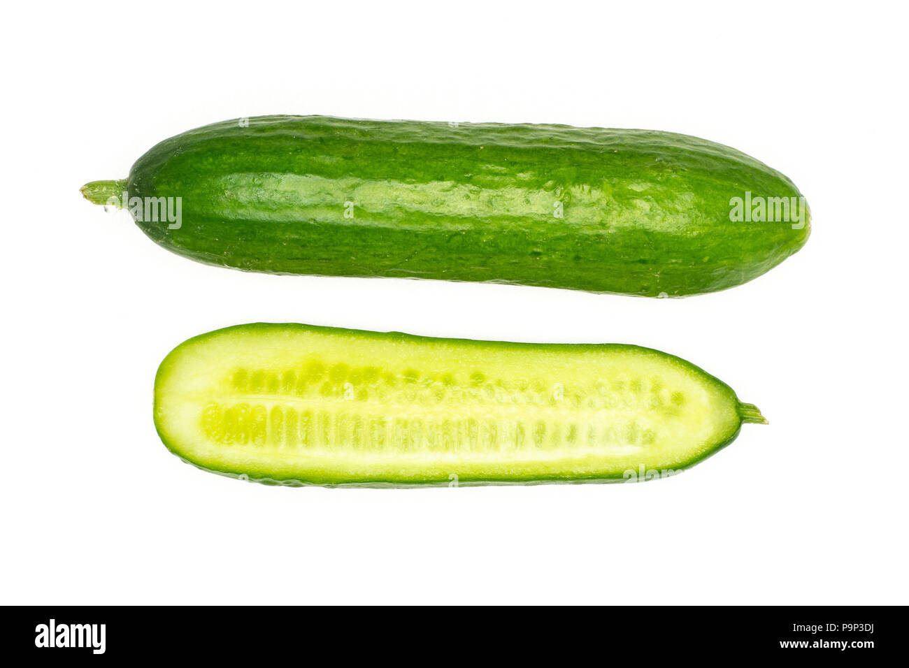 Fresh mini cucumber and one section half flatlay isolated on white ...