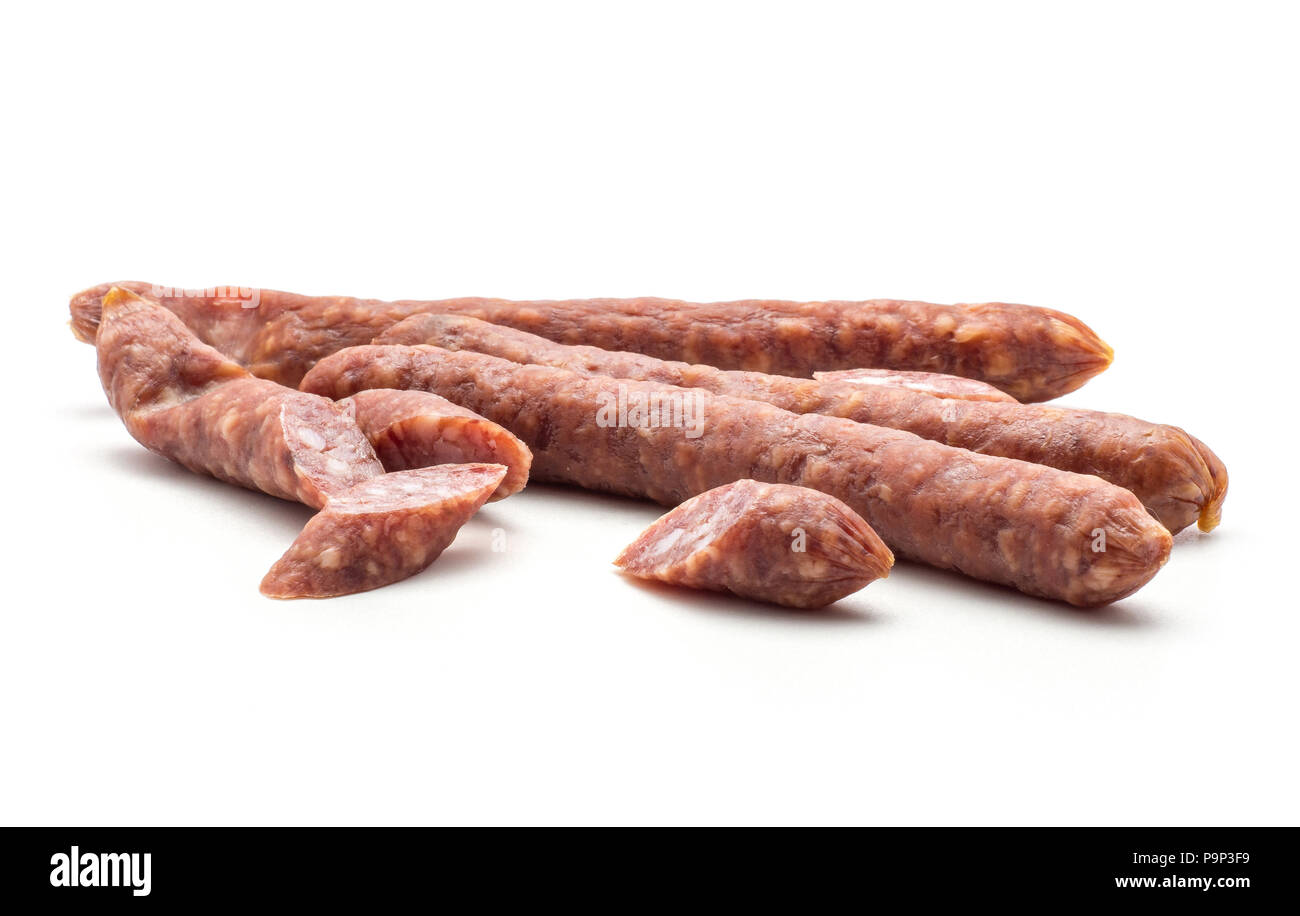 Three Hungarian dry sausages pepperoni with cut pieces isolated on ...
