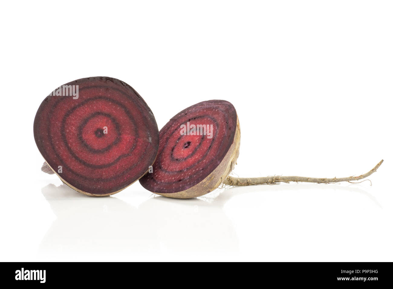 Sliced red beet one cut in two halves isolated on white background ...