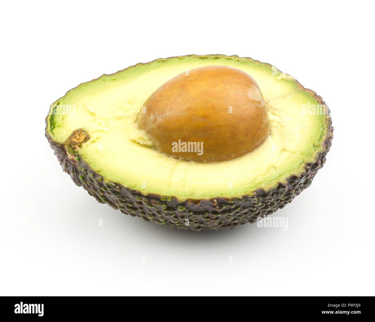 One avocado half with a seed inside isolated on white background ripe ...