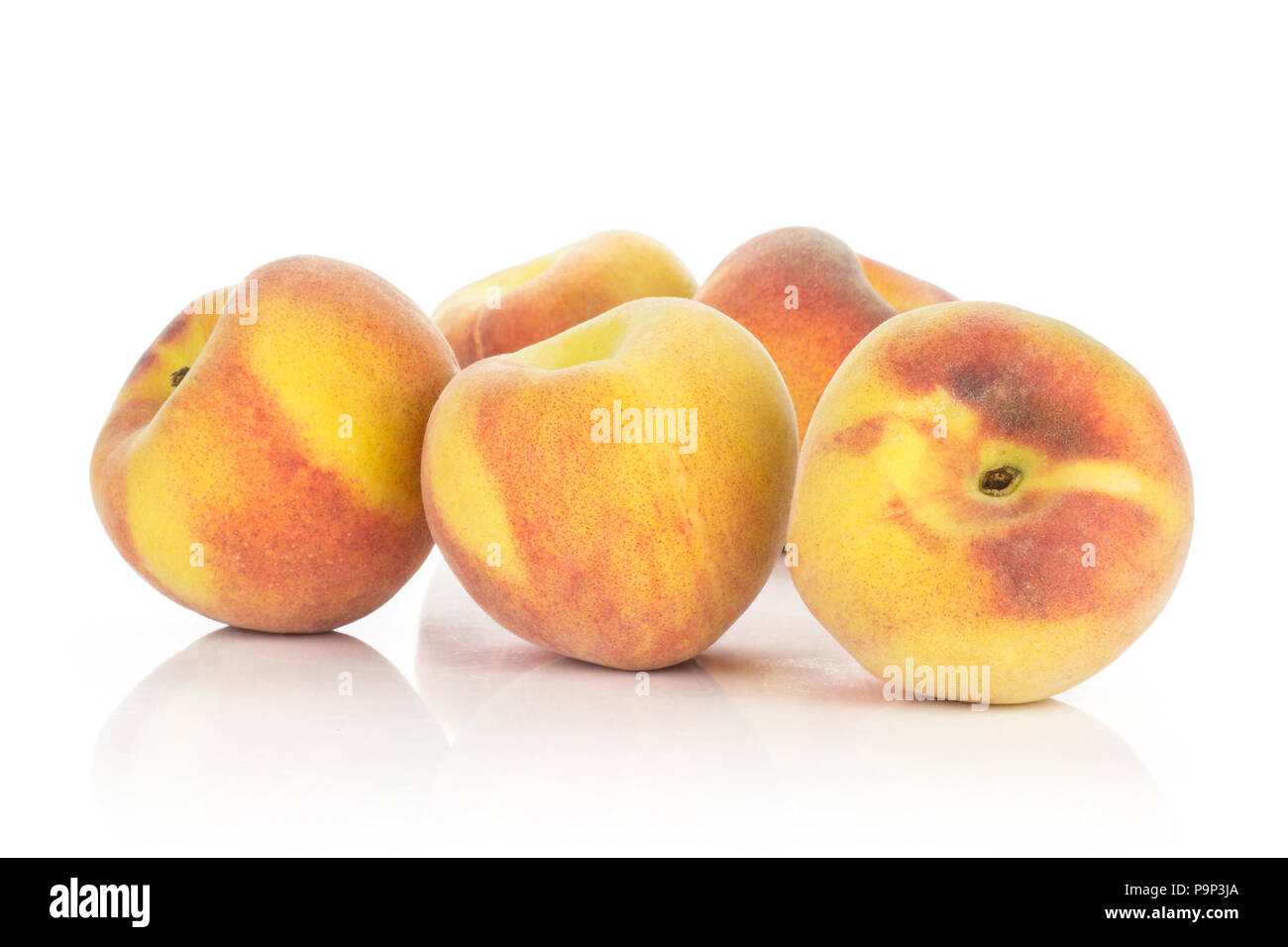 Five ripe yellow peaches isolated on white background Stock Photo - Alamy