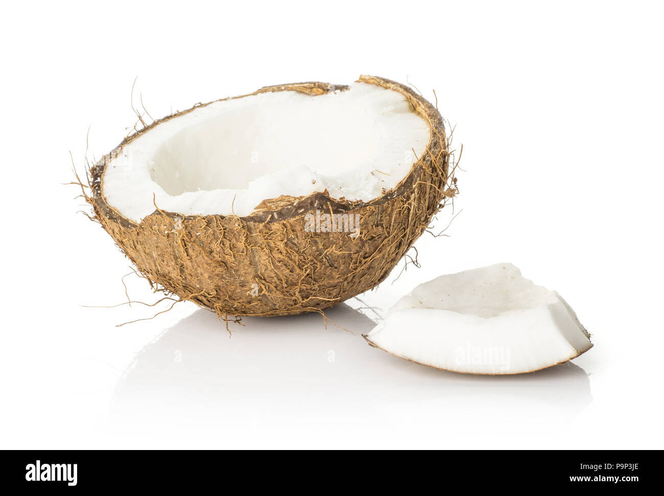 Coconut half with one piece isolated on white background brown fibrous ...