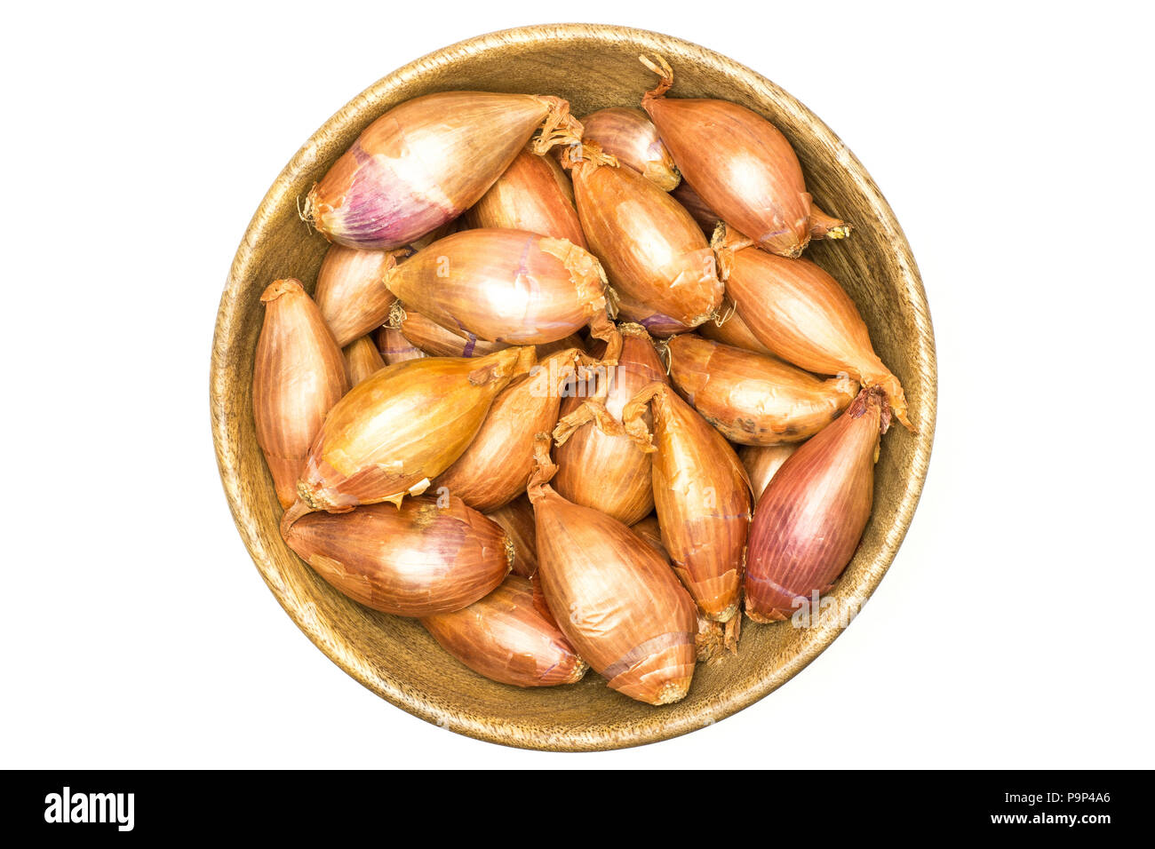 Long shallot in a wooden bowl top view isolated on white background ...