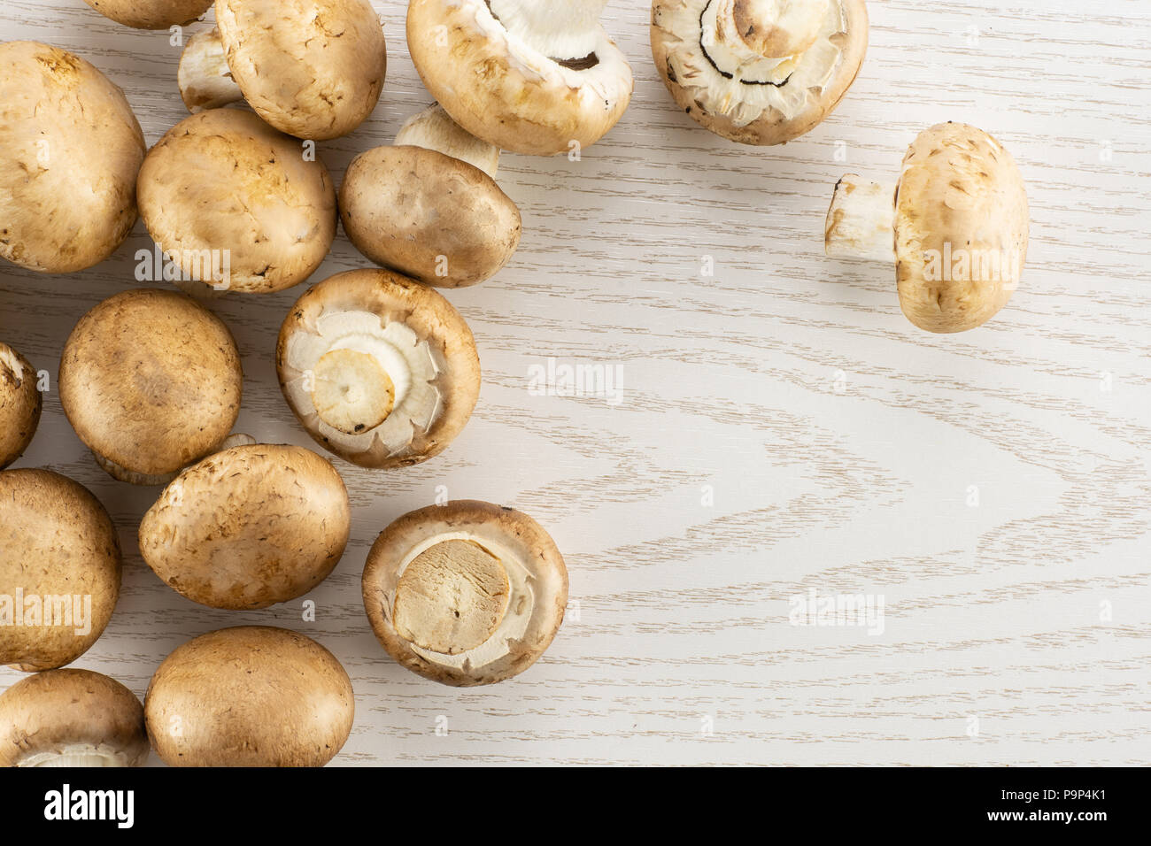 Fresh raw brown champignons table top on grey wood background Stock ...