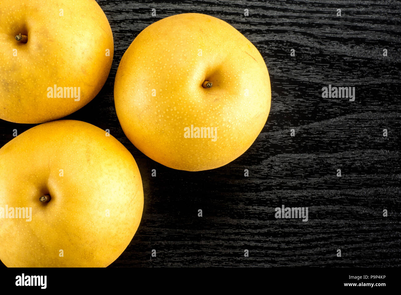 Chinese golden pears top view Nashi variety isolated on black wooden ...