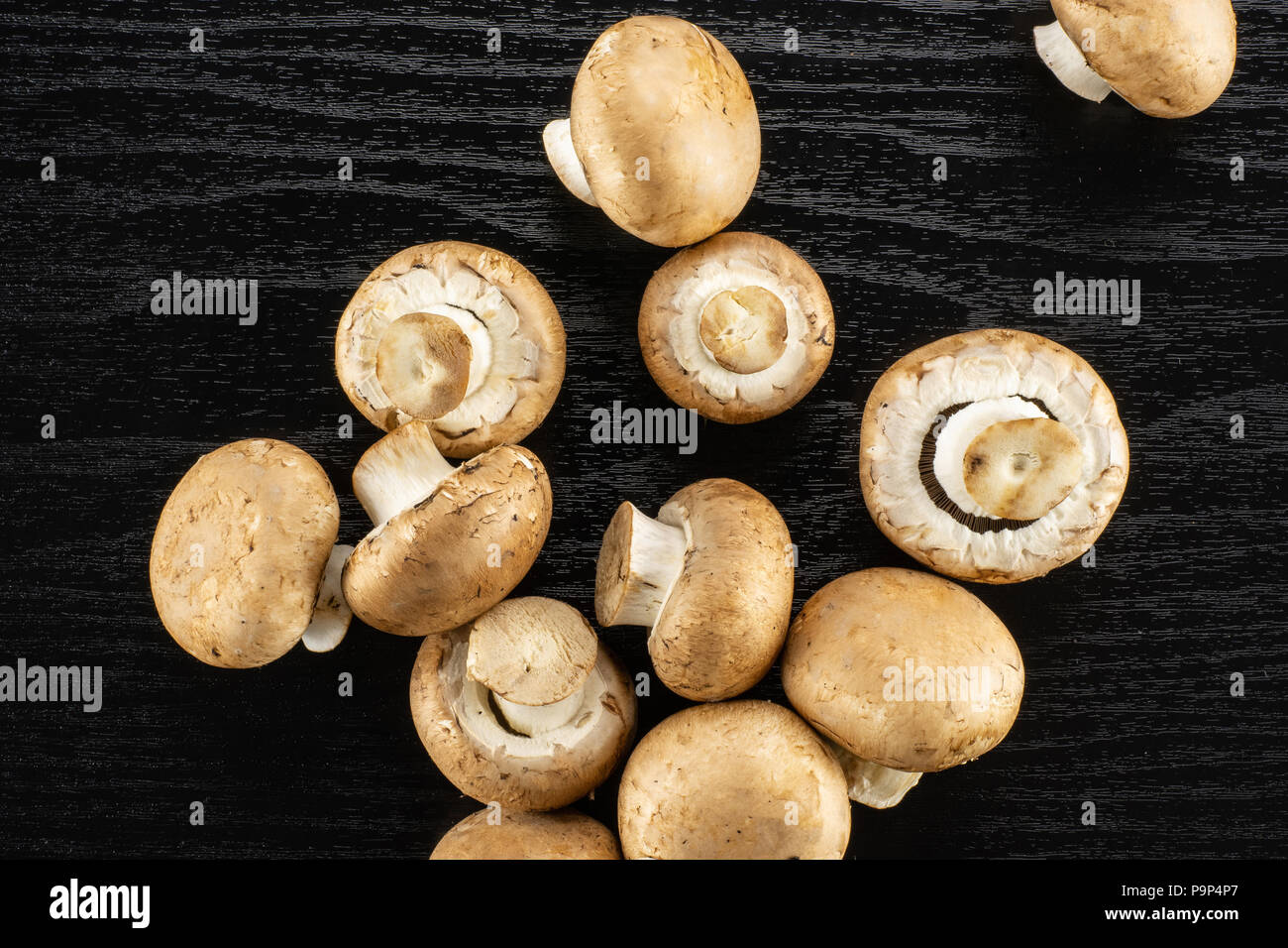 Raw fresh brown champignons table top on black wood background Stock ...