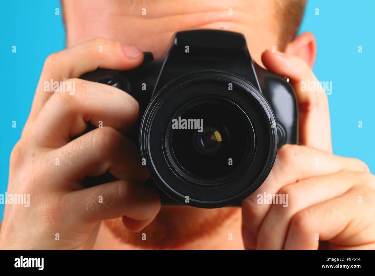 photographer with camera in hand looking through the camera lens Stock ...