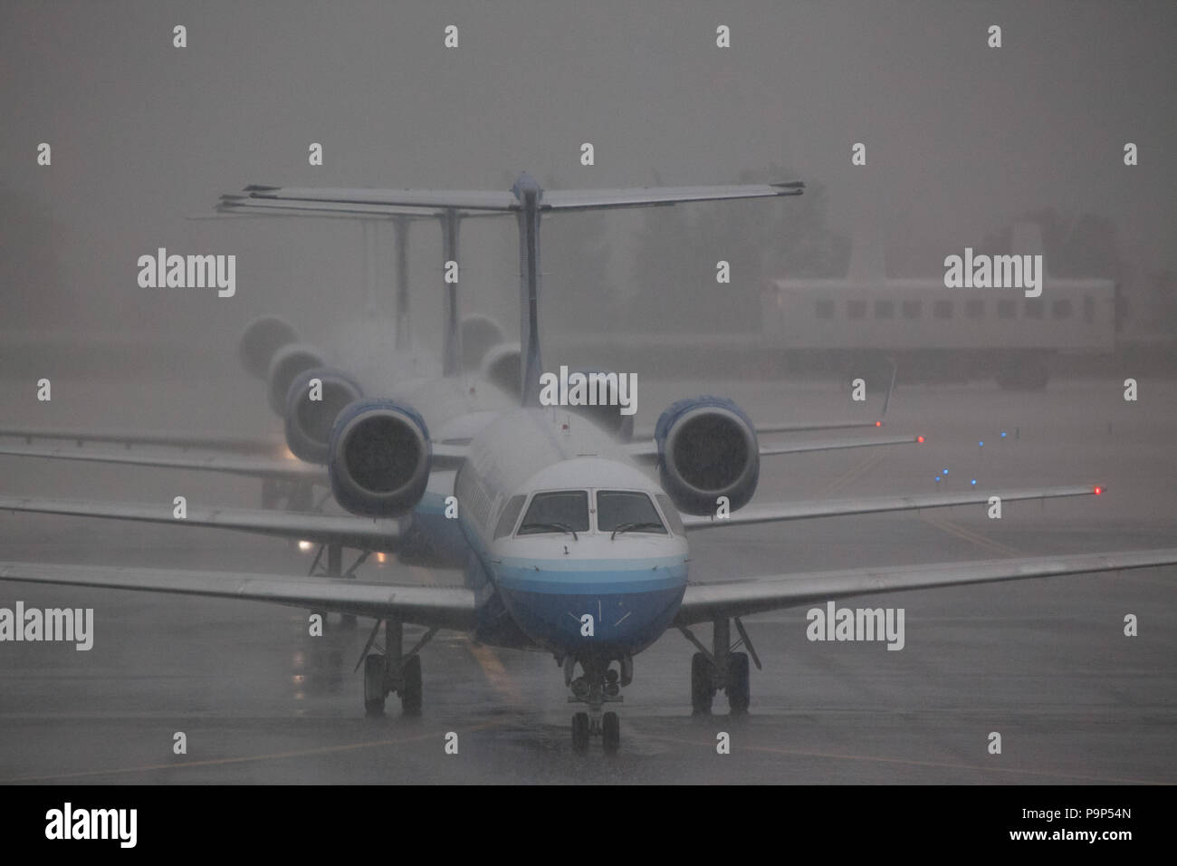 A line-up of regional jet airplanes lead by Embraer-145 of United ...