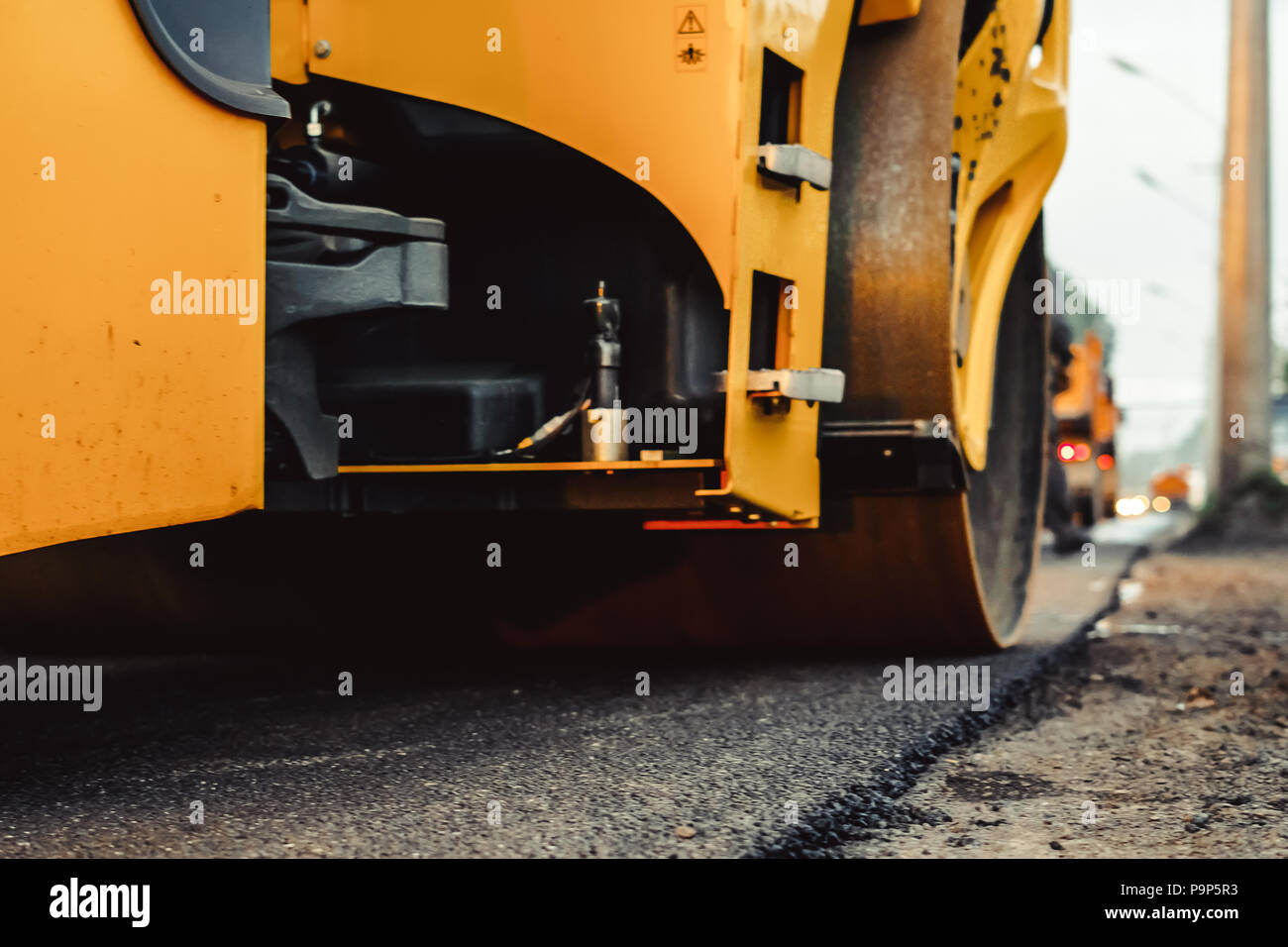 Road construction works with roller compactor machine and asphalt ...